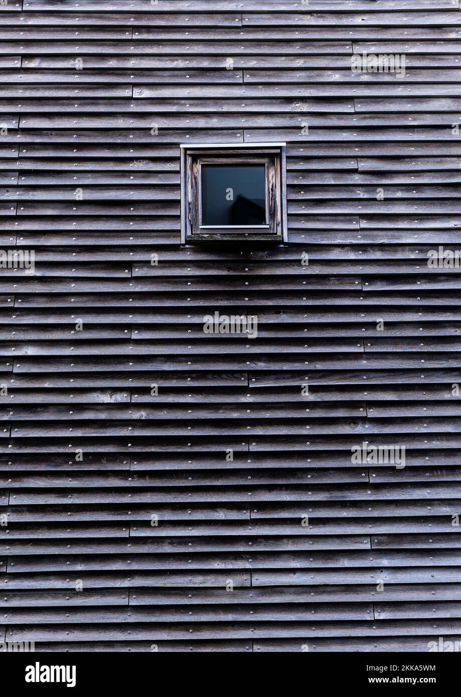 Small single square window on a modern architecture building ...