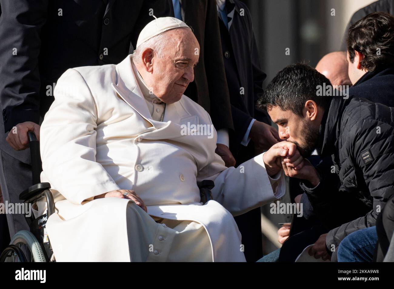 A man kisses the hand of Pope Francis during the traditional Wednesday ...