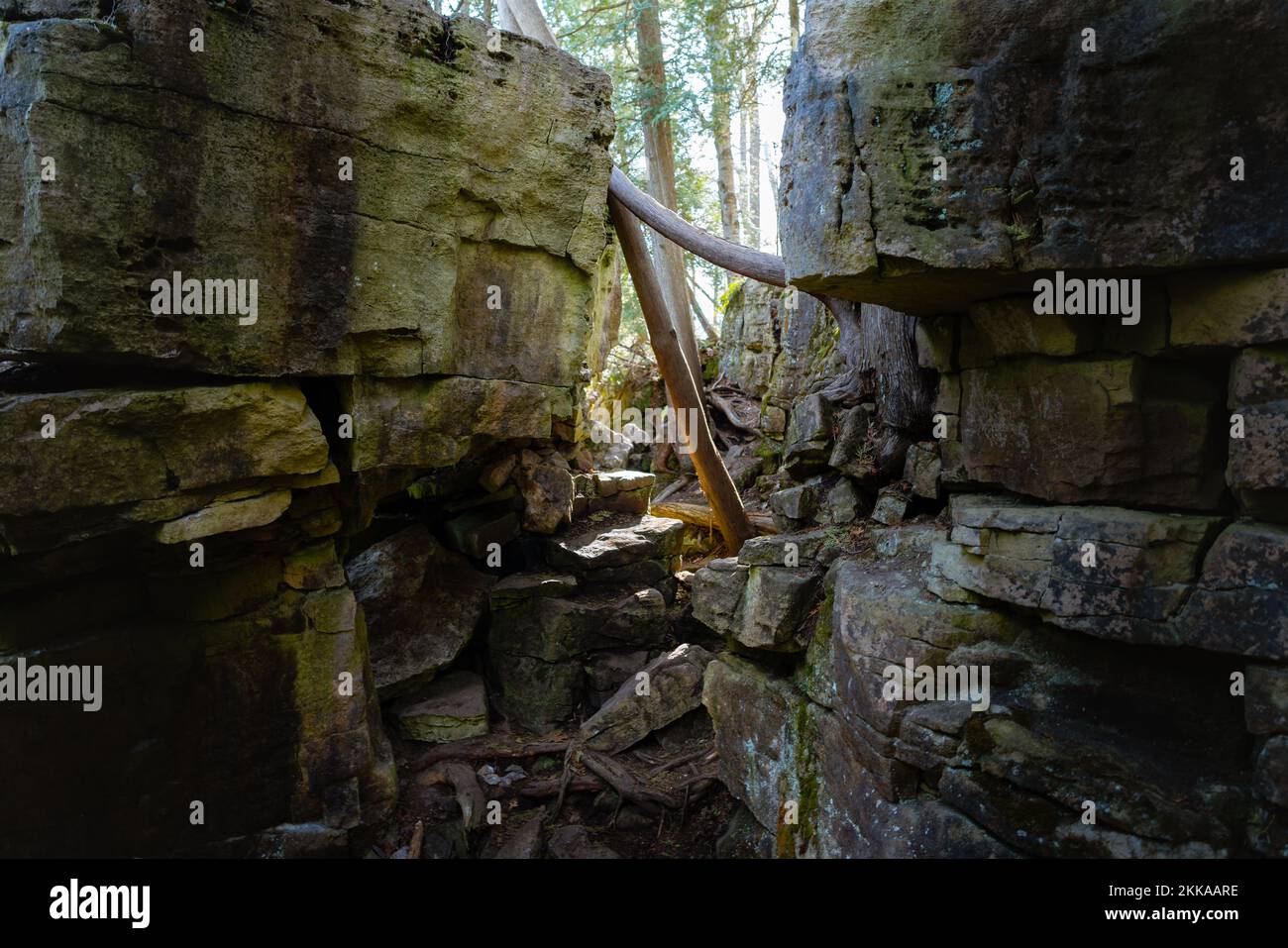 A narrow chasm separates two large sections of limestone Stock Photo ...