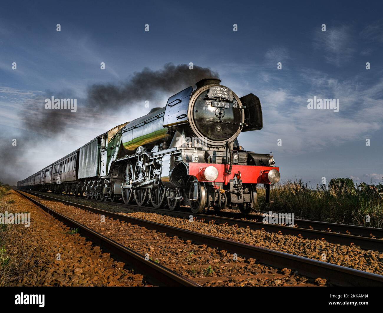 The Flying Scotsman steam train on the rails against a blue sky Stock ...