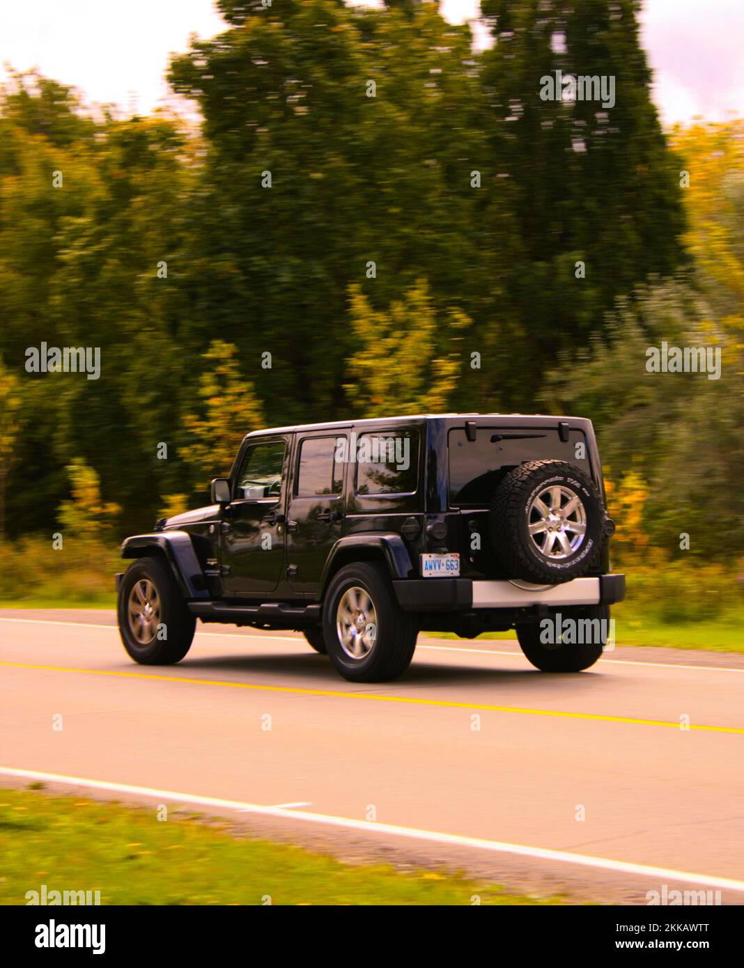 A black Jeep Wrangler on the road Stock Photo - Alamy