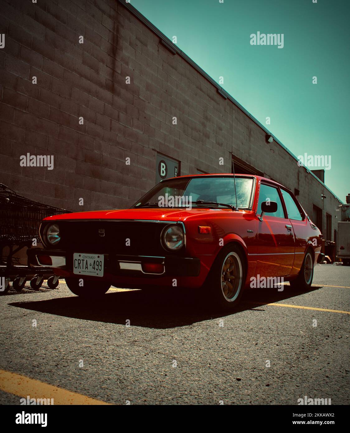 A red retro Toyota Corolla KE70 parked outside Stock Photo - Alamy