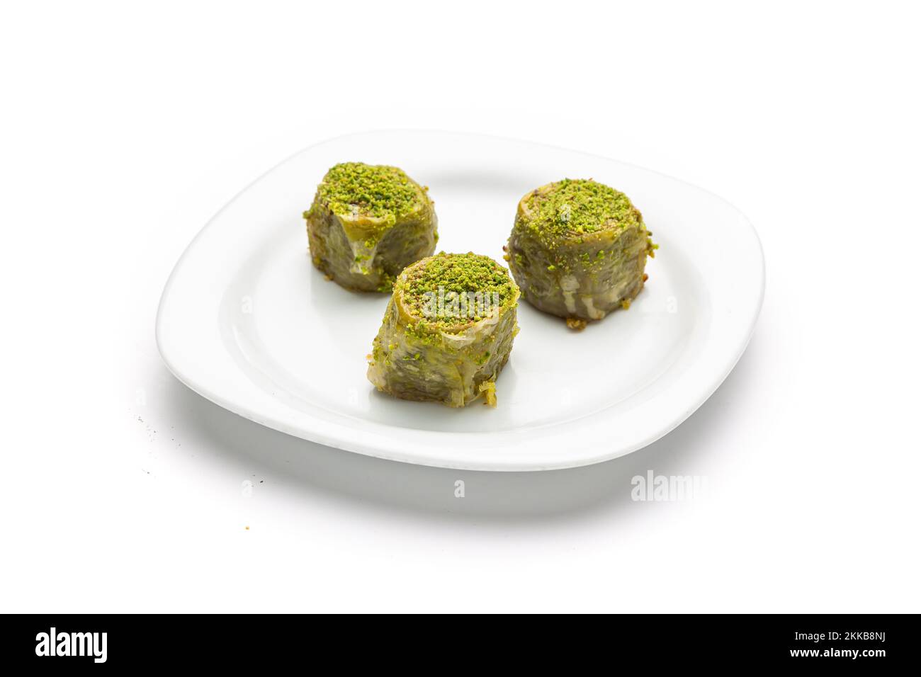 Pieces of green baklava served on a plate isolated on white background ...