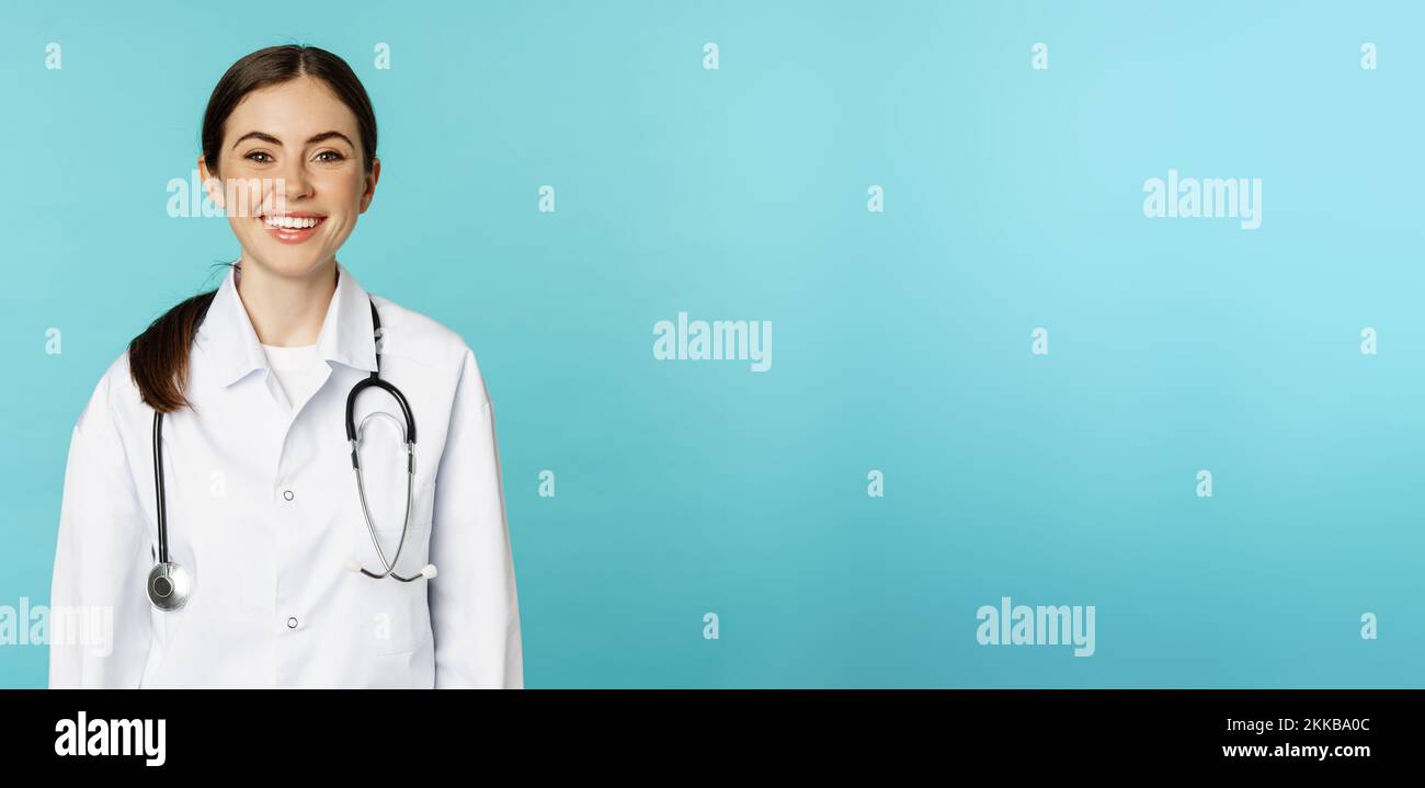 Smiling healthy medical worker, young woman doctor looking happy ...