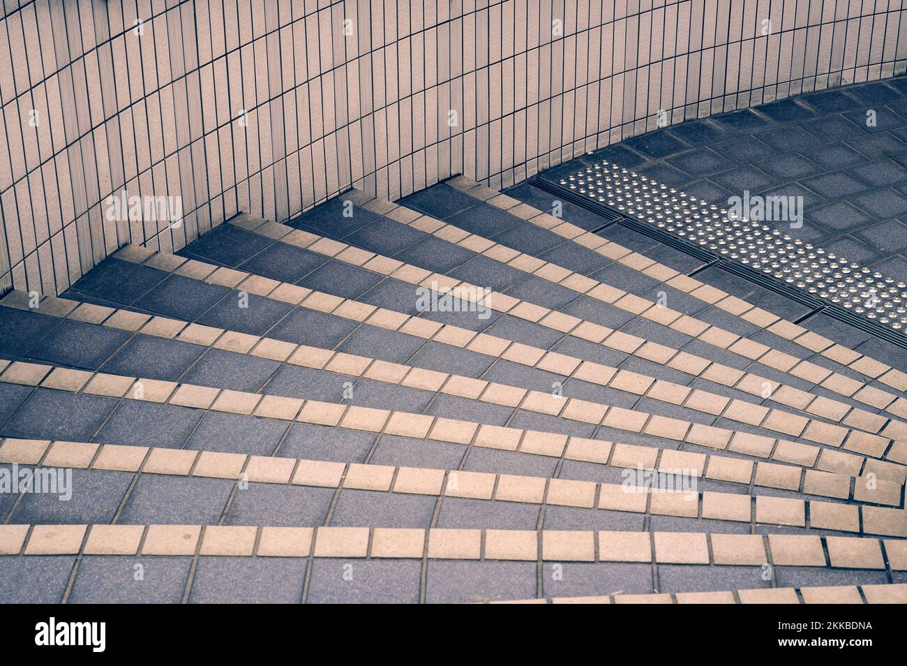 A descending curving staircase with ceramic tiled floor Stock Photo - Alamy