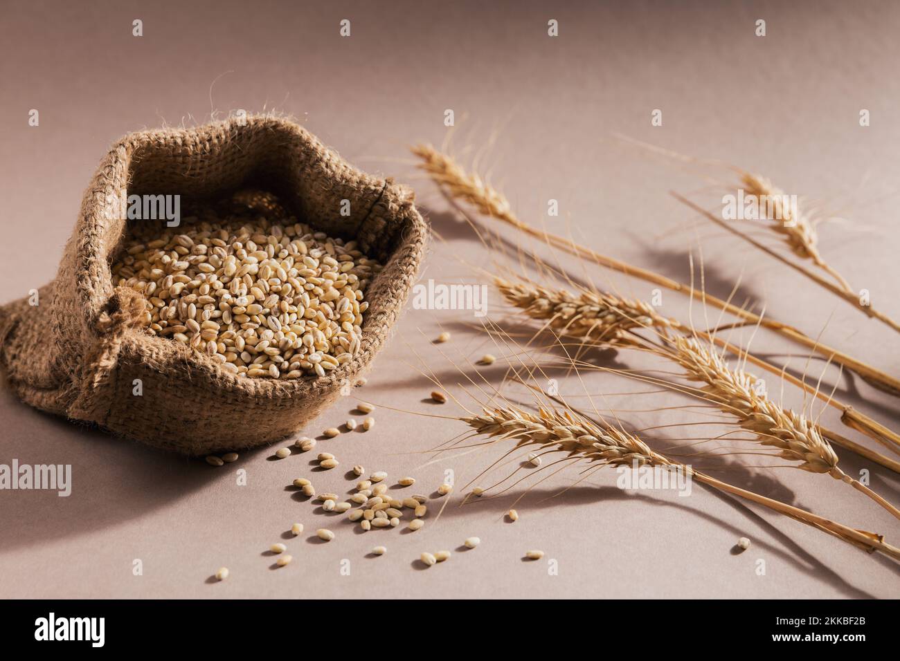 Burlap bag of dry raw broken pearl barley cereal grain Stock Photo - Alamy