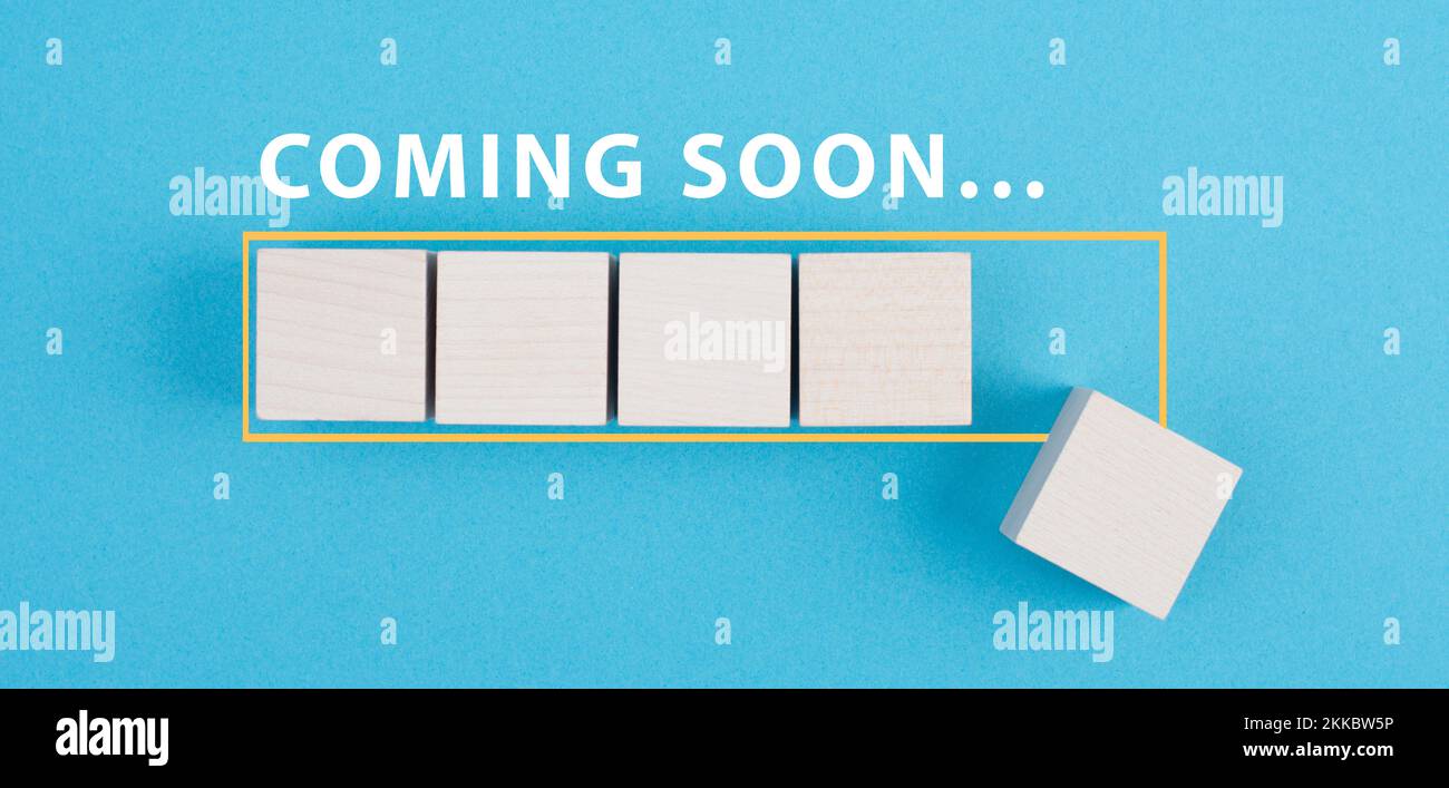 Coming soon is standing over a loading bar, hand puts the last cube ...