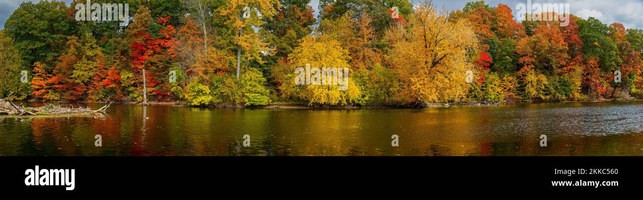 Vivid fall foliage on the Grand River river in Grand Ledge with cloudy ...