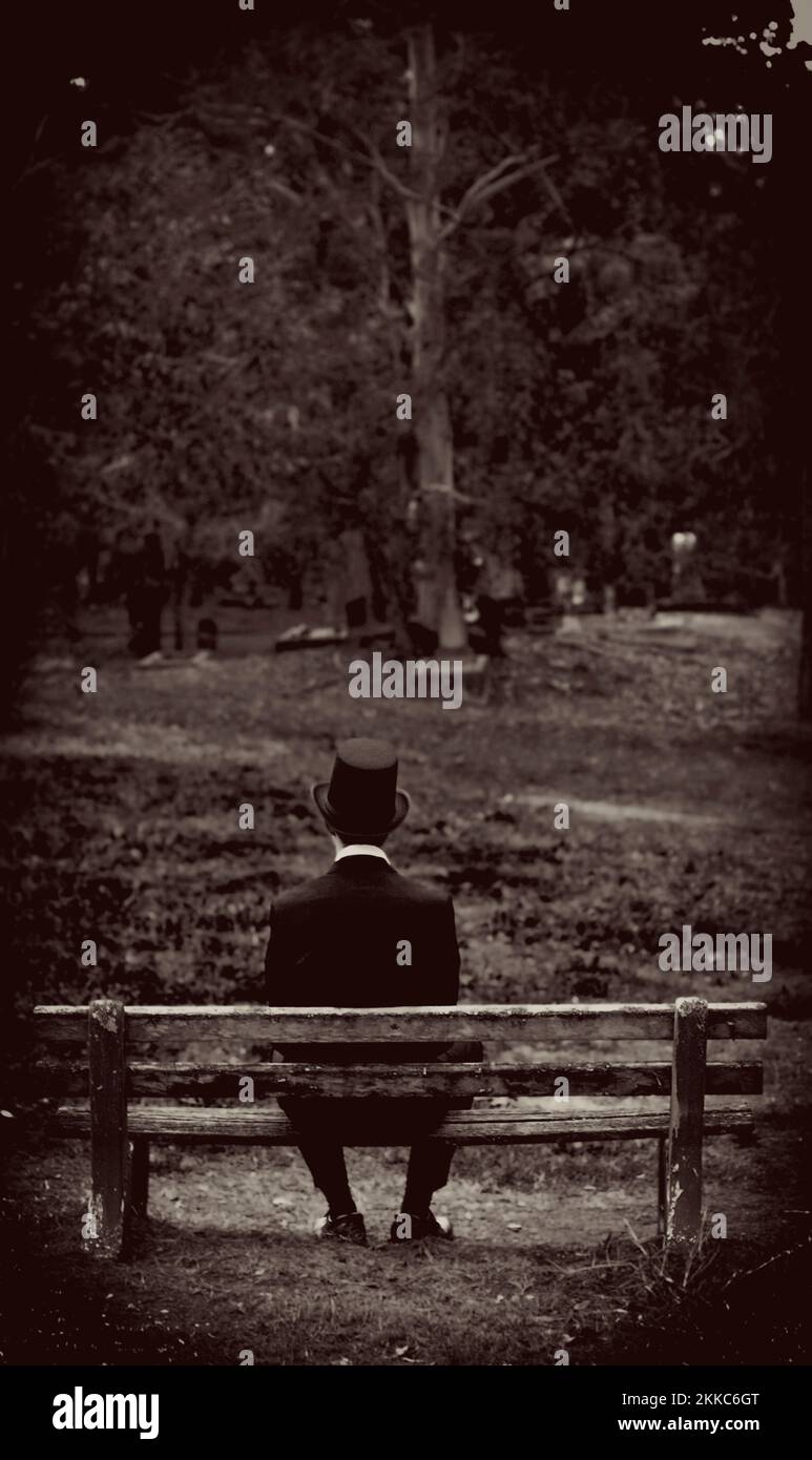 Vintage Sepia Toned Image Of A Olden Day Man Sitting On A Park Bench In ...