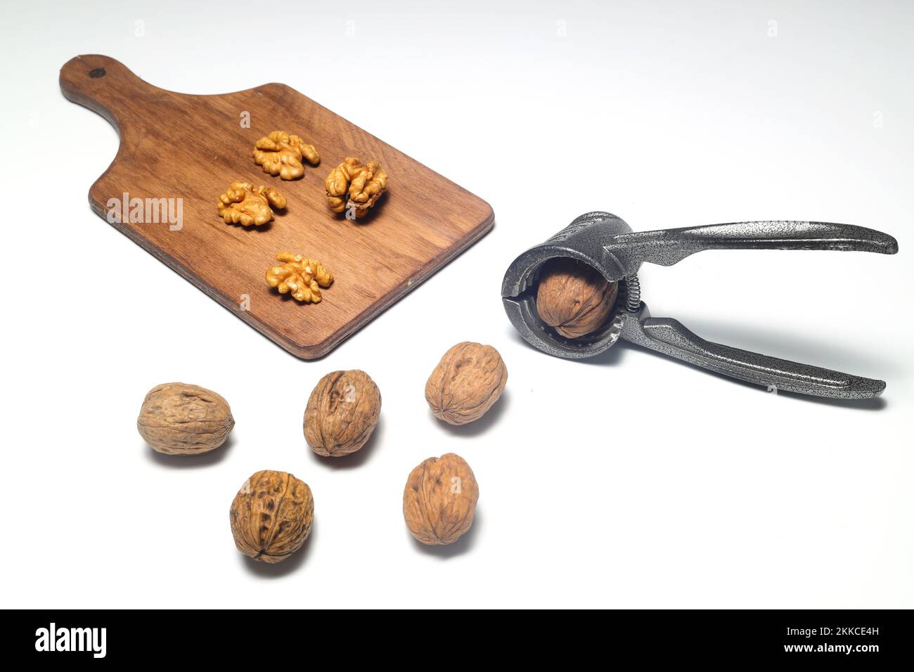 Walnuts with nutcracker isolated on white background Stock Photo - Alamy