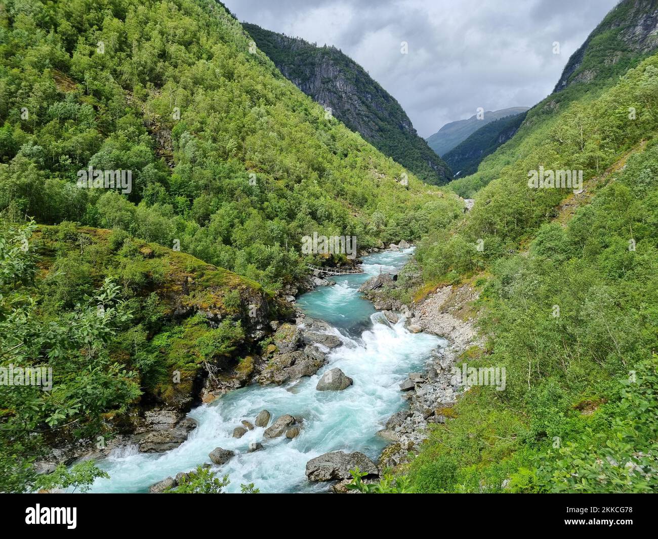 A beautiful shot of a river between mountains on a cloudy day Stock ...