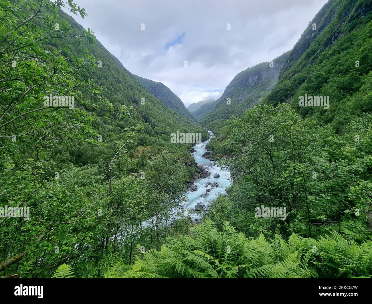 A beautiful shot of a river between mountains on a cloudy day Stock ...