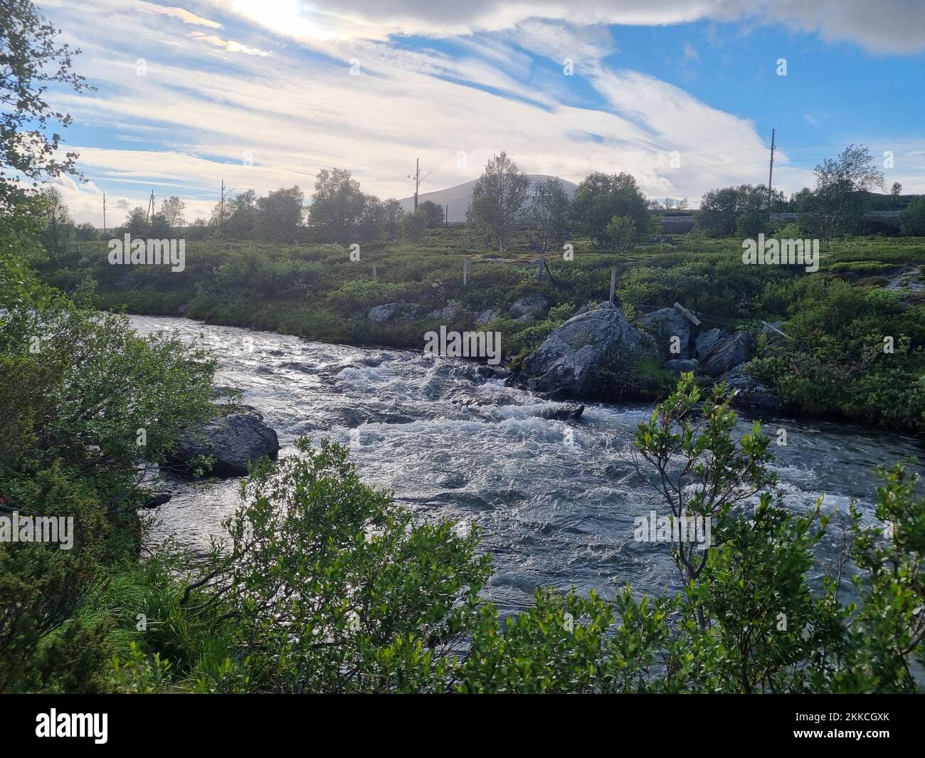 A beautiful shot of a river between mountains on a cloudy day Stock ...