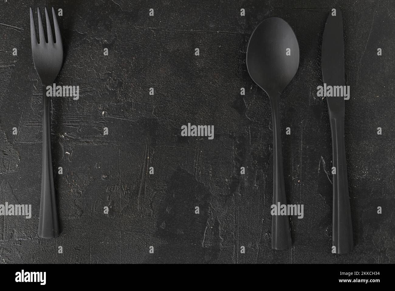 Overhead shot of silverware on black table with copy space Stock Photo ...