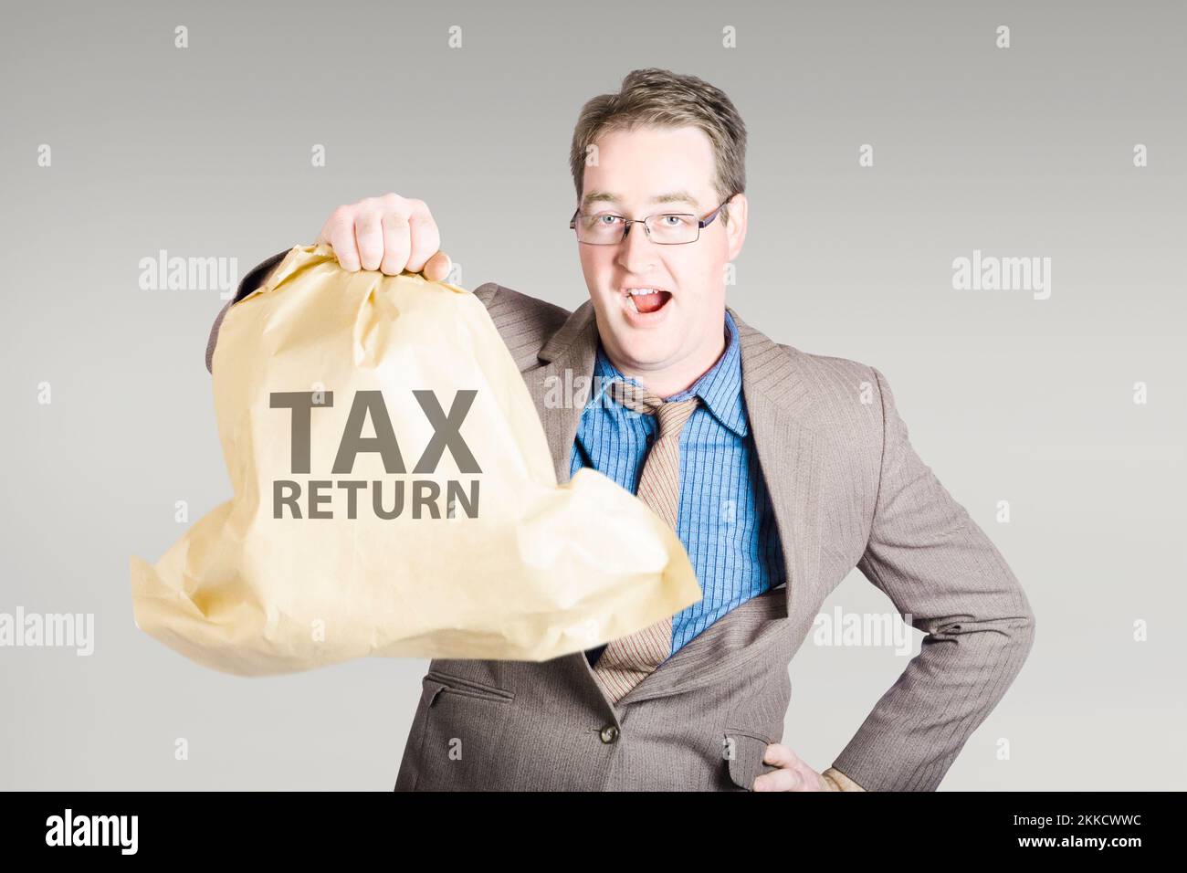Business man holding income tax return with a happy expression of ...