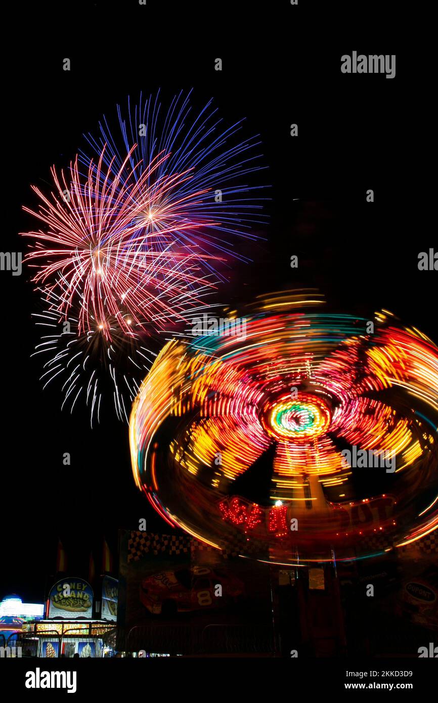 A vertical low-angle long exposure of a carnival ride in Sheffield park ...