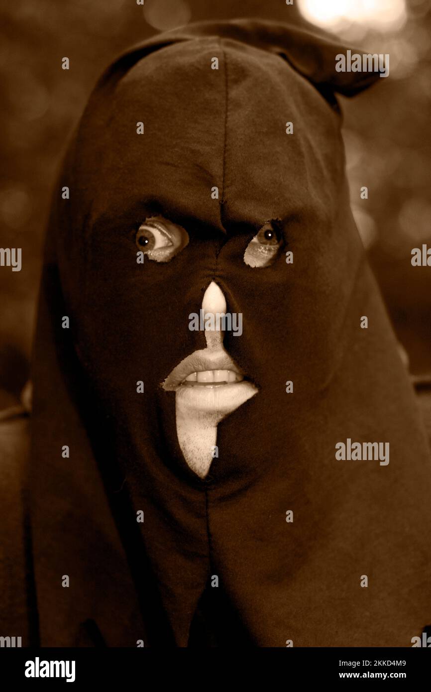 The Face Of A Historical Headsman Wearing A Black Hooded Mask Over His ...