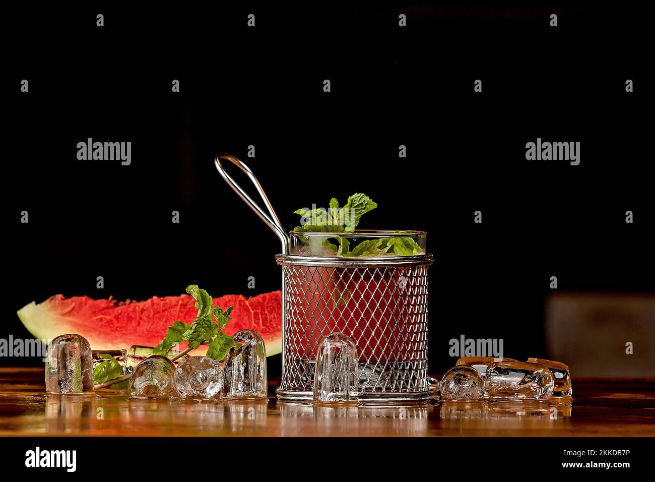 A glass of cold delicious watermelon juice, ice cubes, and a watermelon ...
