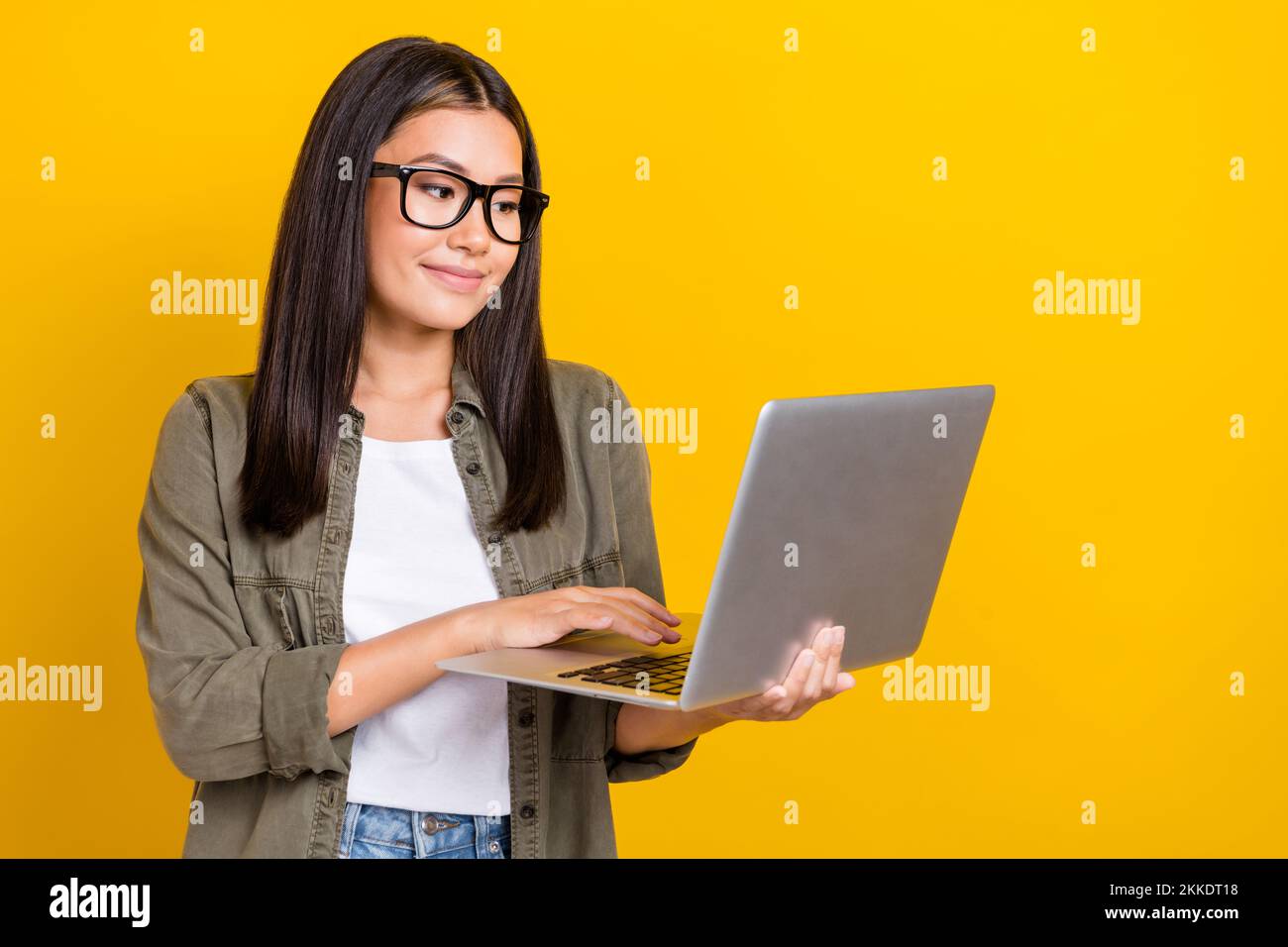 Photo of positive cheerful smart girl with brunette hair wear gray ...
