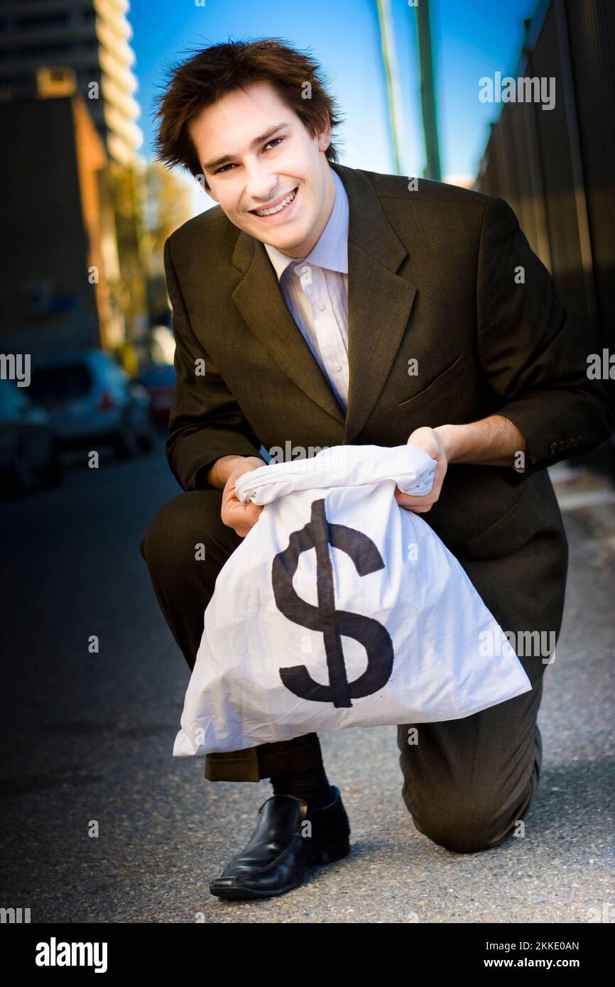Handsome male in suit kneeling hi-res stock photography and images - Alamy