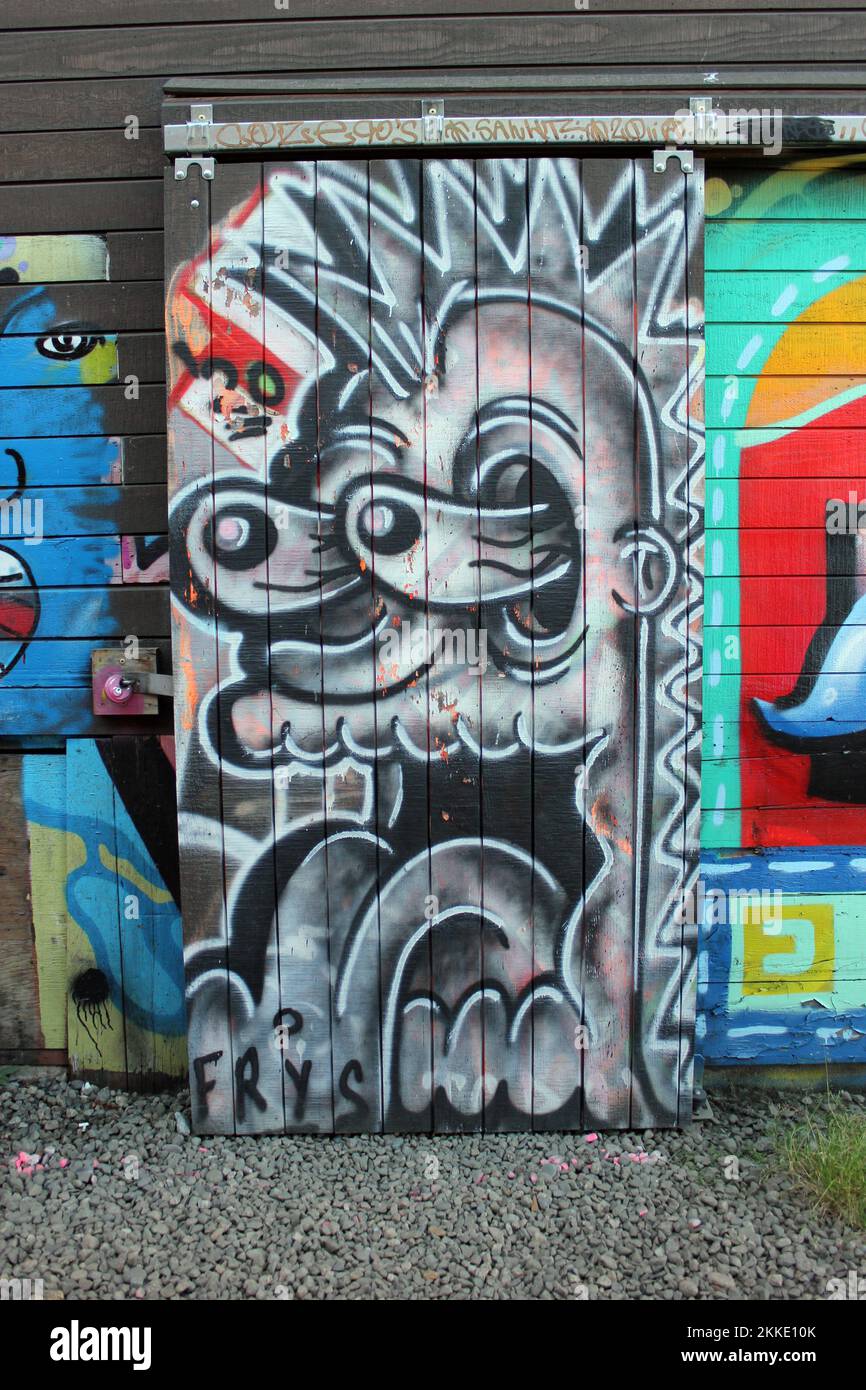 A vertical shot of graffiti on the building wall Stock Photo - Alamy