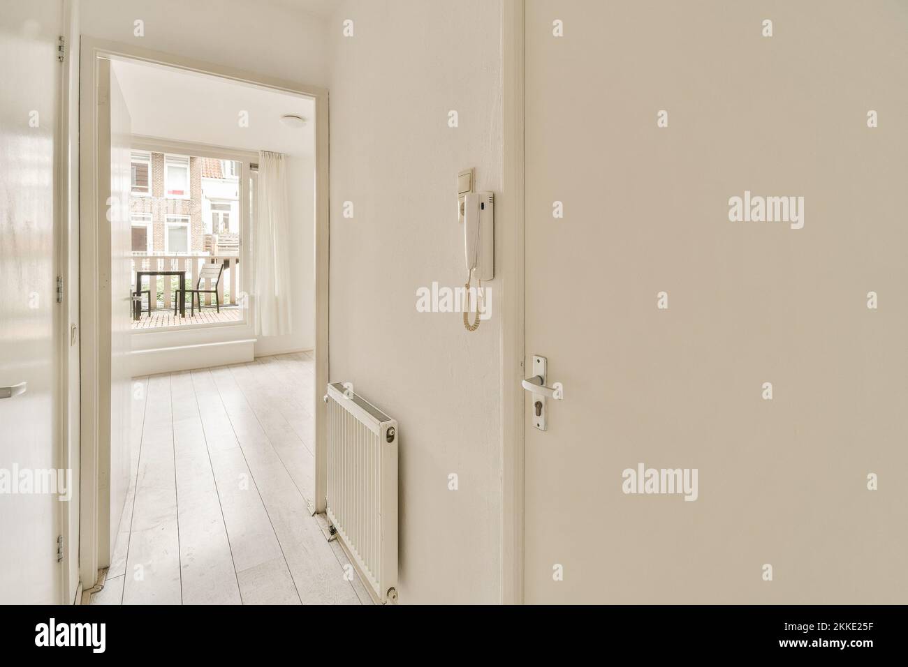 Interior of narrow corridor with telephone and radiator in daylight ...