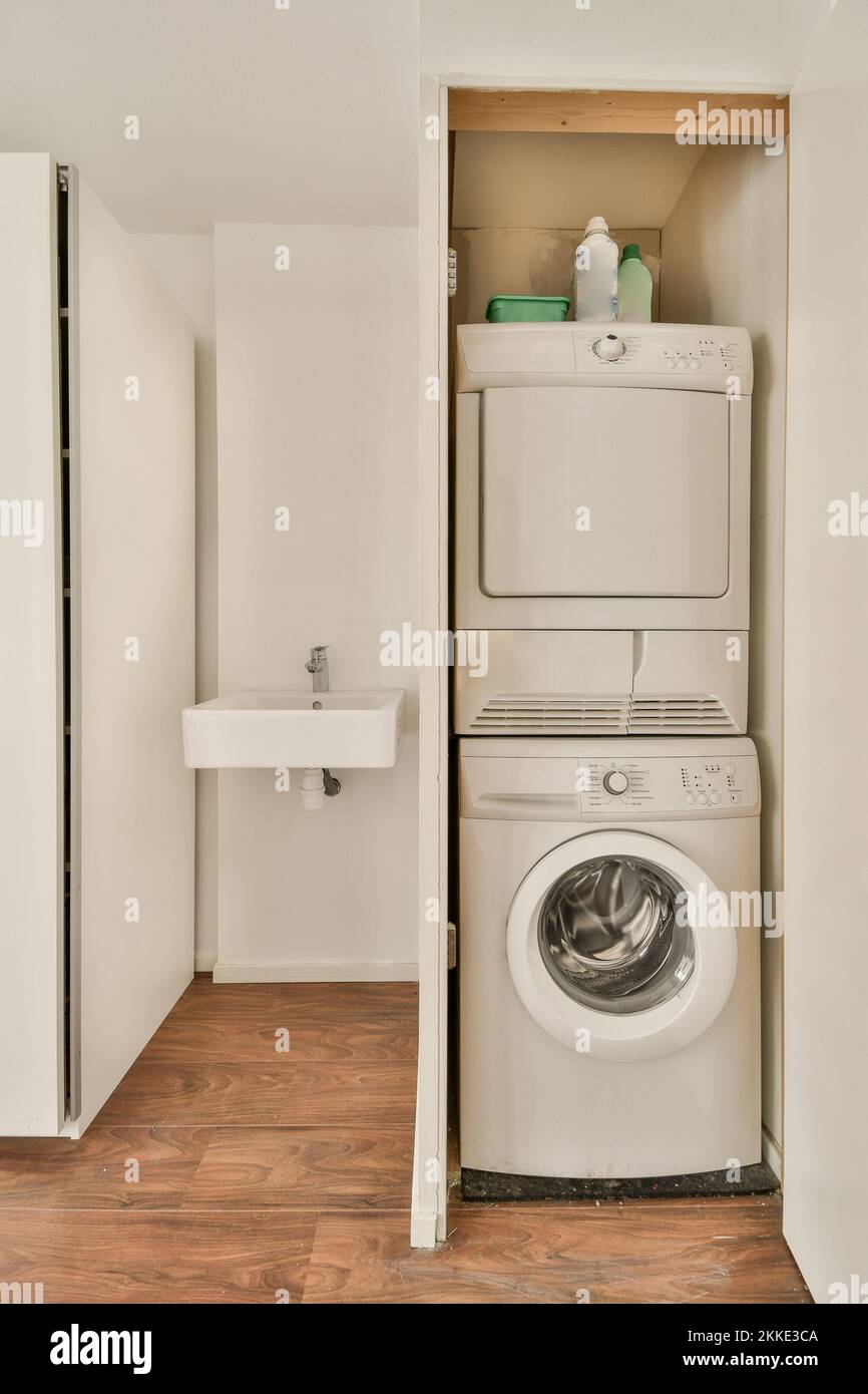 Laundry room in light bathroom with washing machine and with white ...