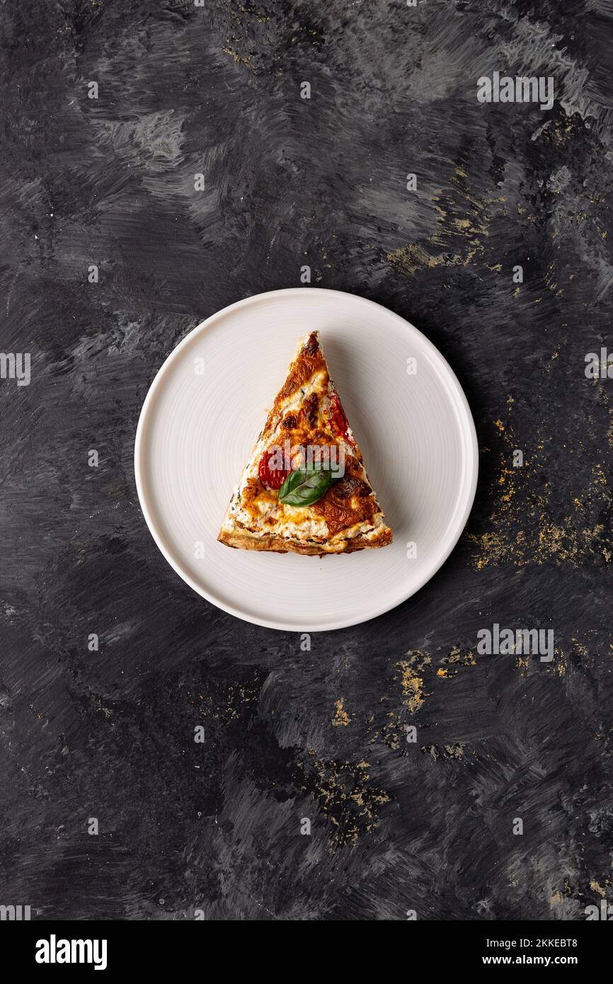 A vertical top view of an appetizing pizza slice, pizza margherita with ...