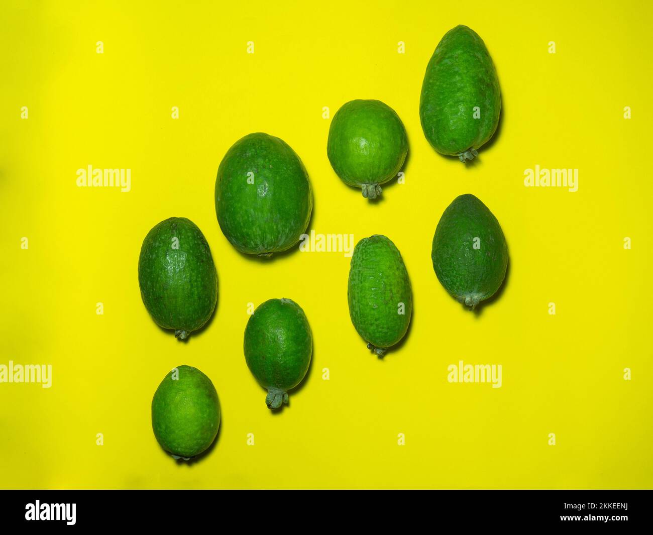 Feijoa on a yellow background. Green fruit on yellow. Feijoa background ...