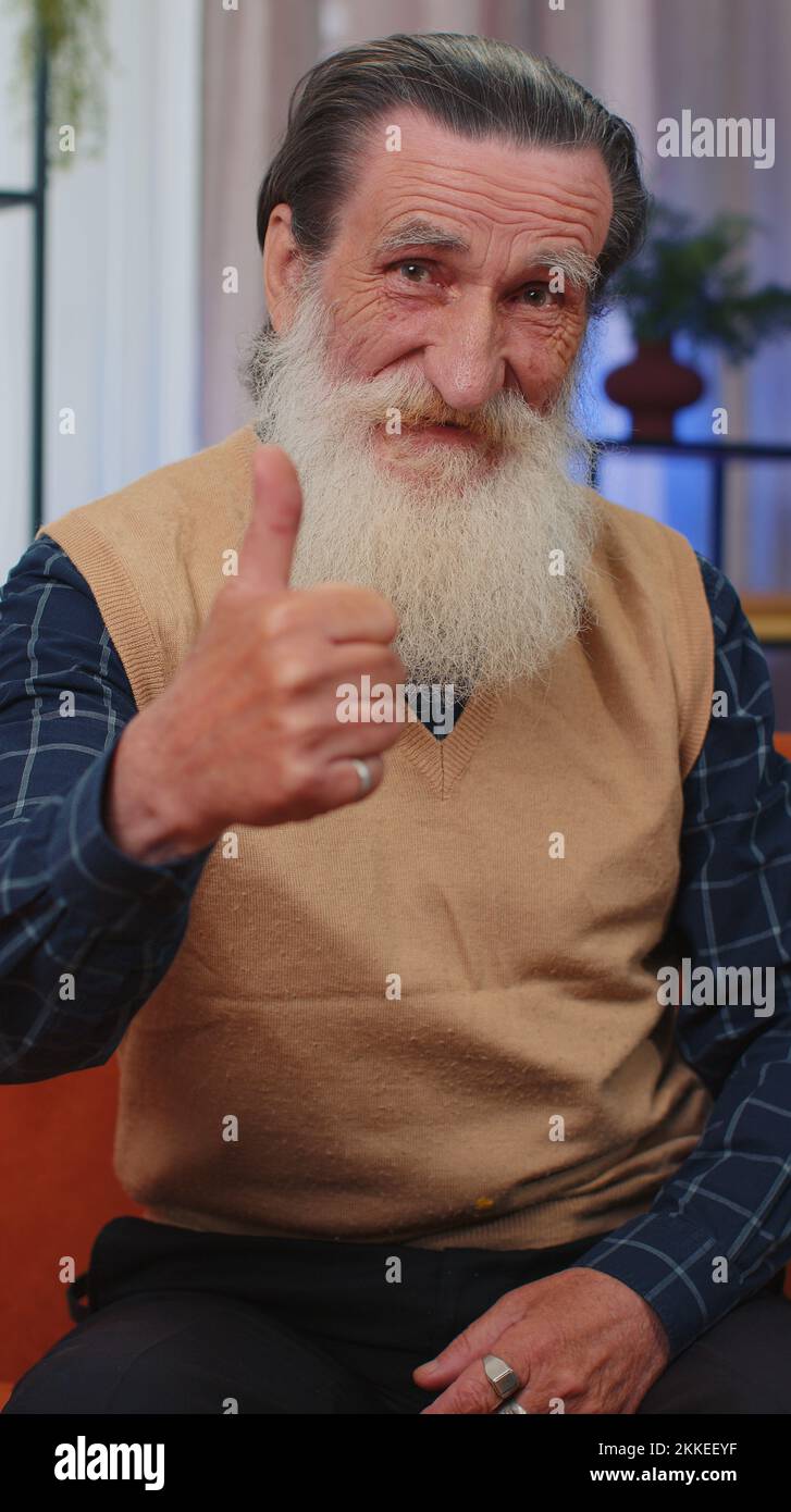 Like. Happy senior old grandfather man looking approvingly at camera ...