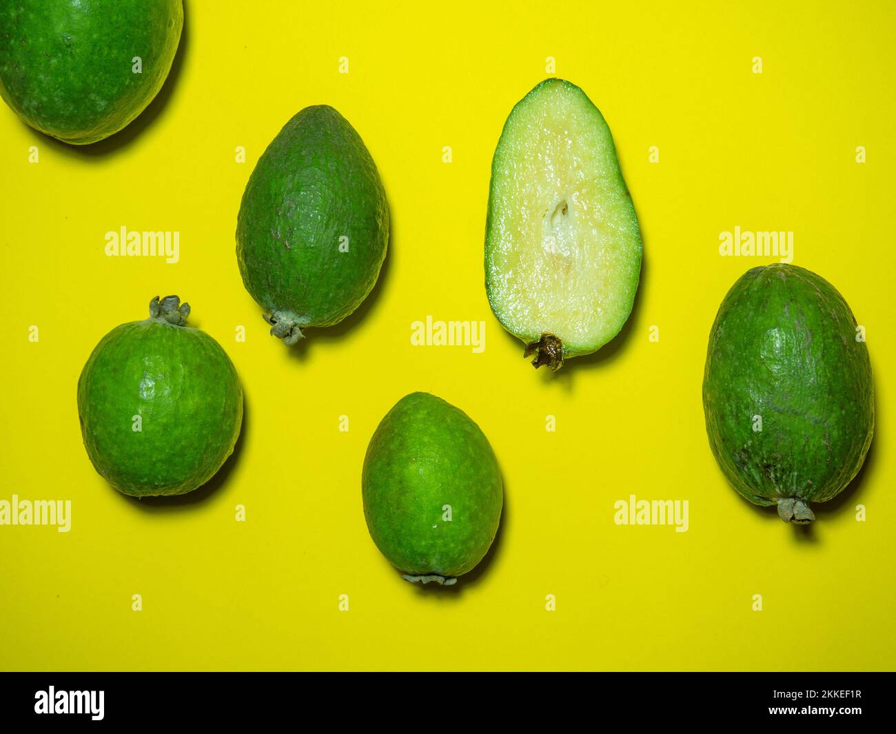 Feijoa on a yellow background. Green fruit on yellow. Feijoa background ...