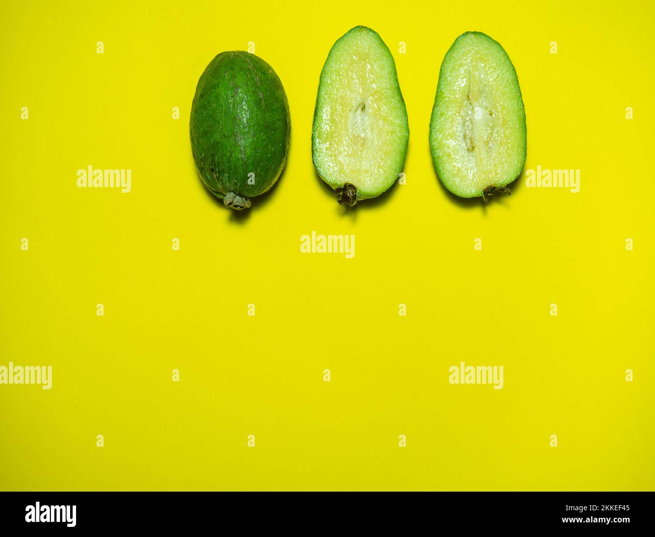 Feijoa on a yellow background. Green fruit on yellow. Feijoa background ...