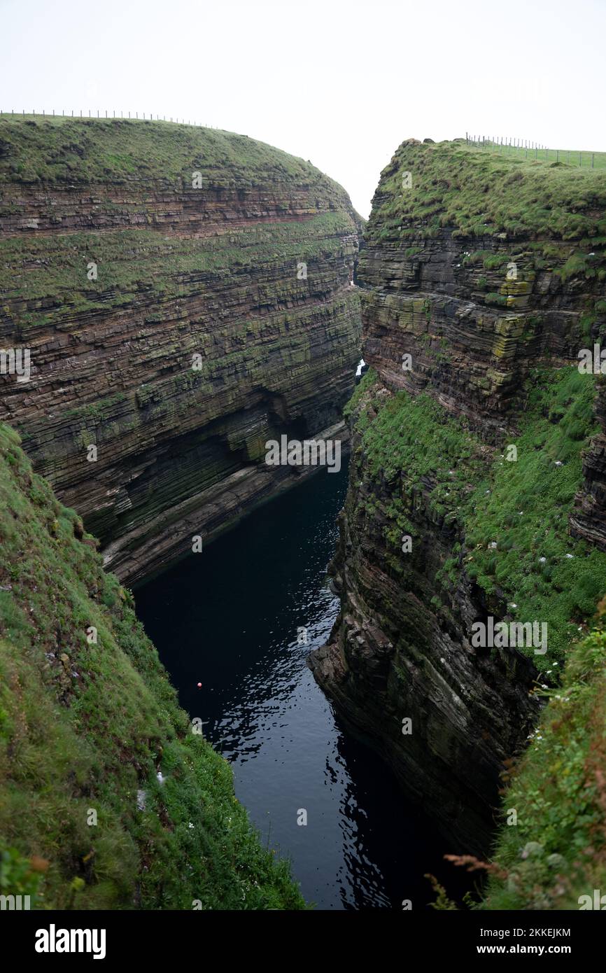 A beautiful view of cliffs with greenery and a river in the middle ...