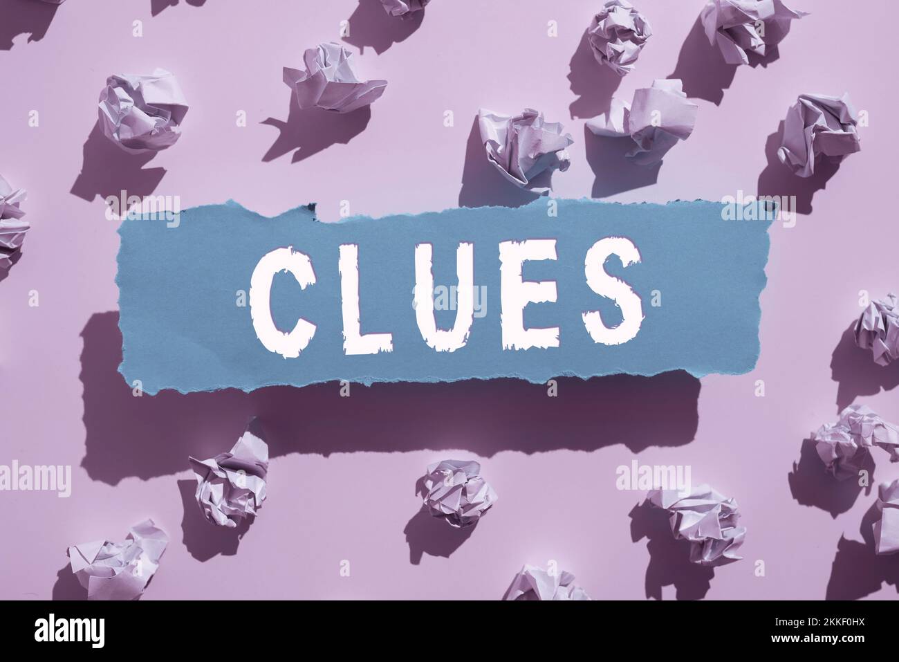 Hand writing sign Clues. Word Written on Piece of evidence information ...