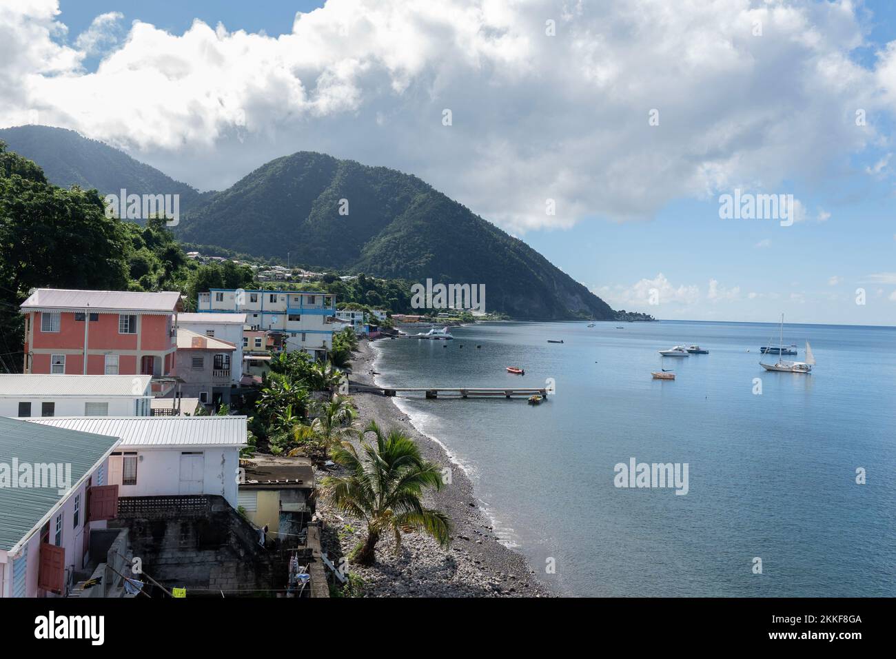Rocky beach in Dominica, Roseau. Caribbean coastal city with access to ...
