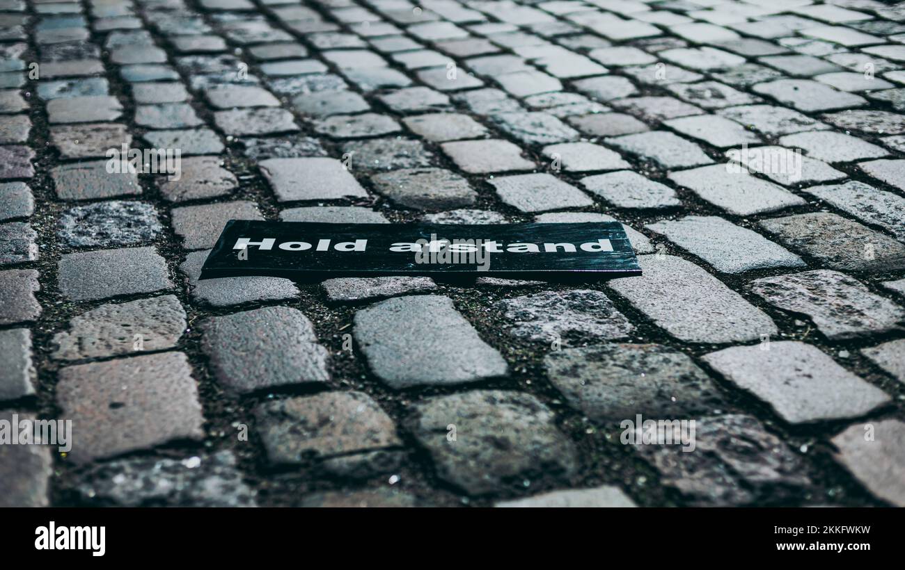 keep your distance sign on the pavement, danish language, scandinavian ...