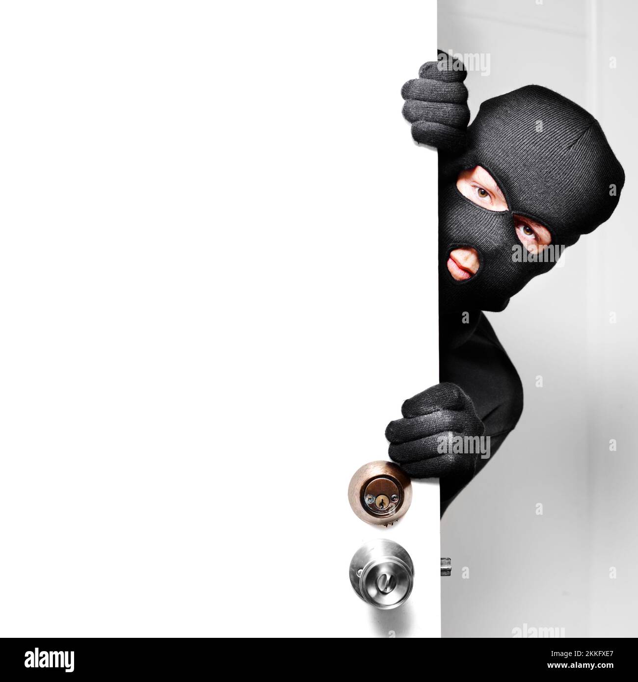 Home burglary concept with a burglar sneaking in a open house door ...