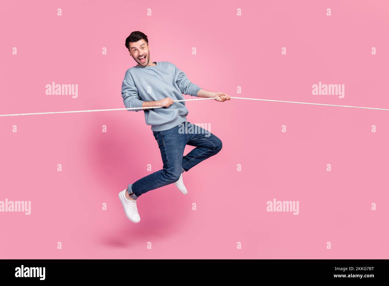 Full length photo of cheerful guy jump up compete for incredible ...