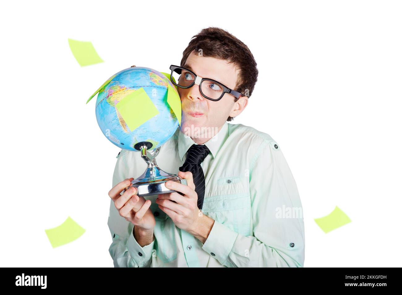 Isolated young businessman holding world globe while contemplating ...