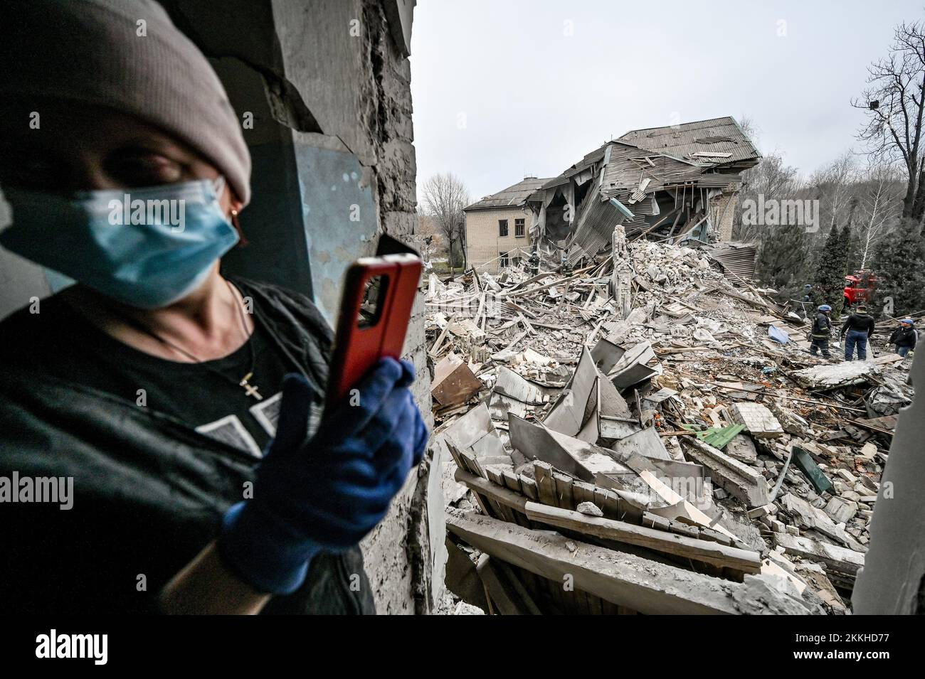 VILNIANSK, UKRAINE - NOVEMBER 23, 2022 - A woman in a face mask stands ...