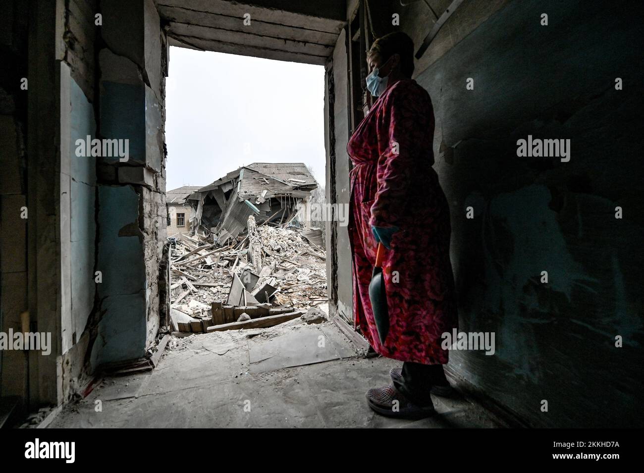 VILNIANSK, UKRAINE - NOVEMBER 23, 2022 - A woman in a face mask stands ...