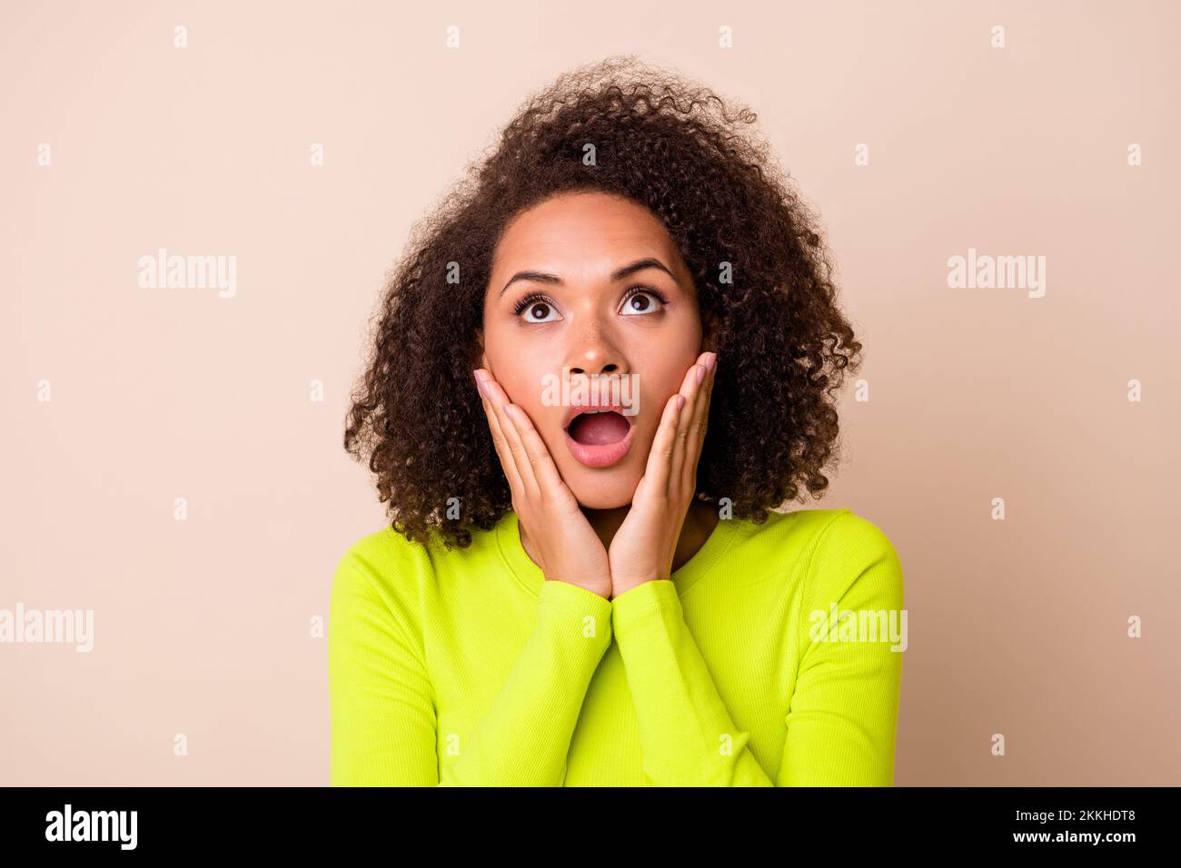 Closeup photo of young funny shocked girl looking up dont know what ...
