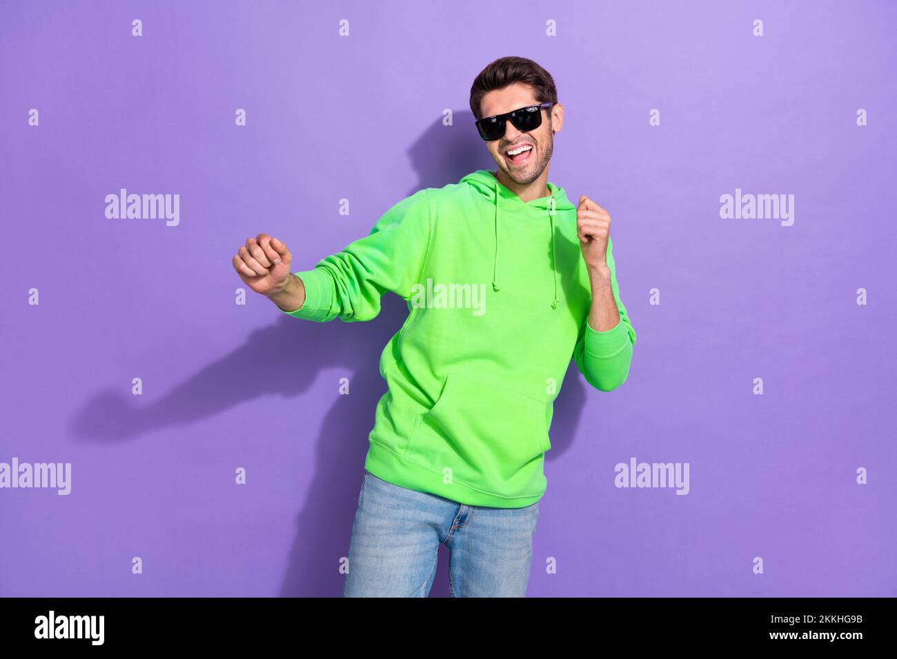 Photo of attractive positive handsome guy brunet hairdo dressed green ...