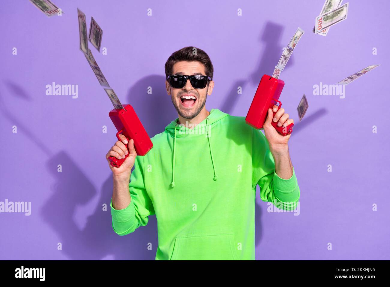 Portrait of positive impressed guy brunet hairdo wear green hoodie hold ...