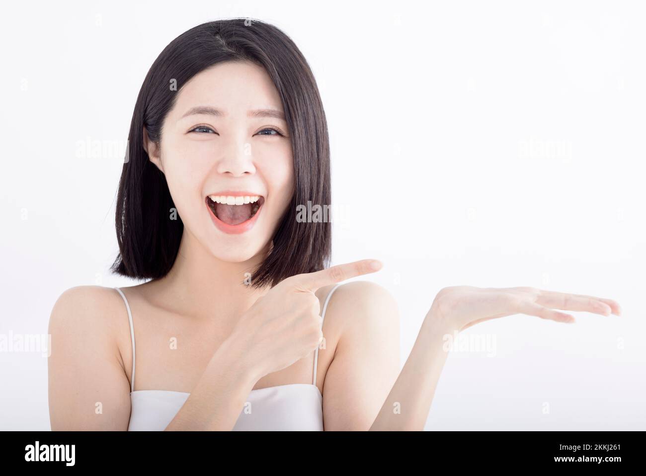 Excited Young beauty with Clean Fresh Skin and showing product on hand ...