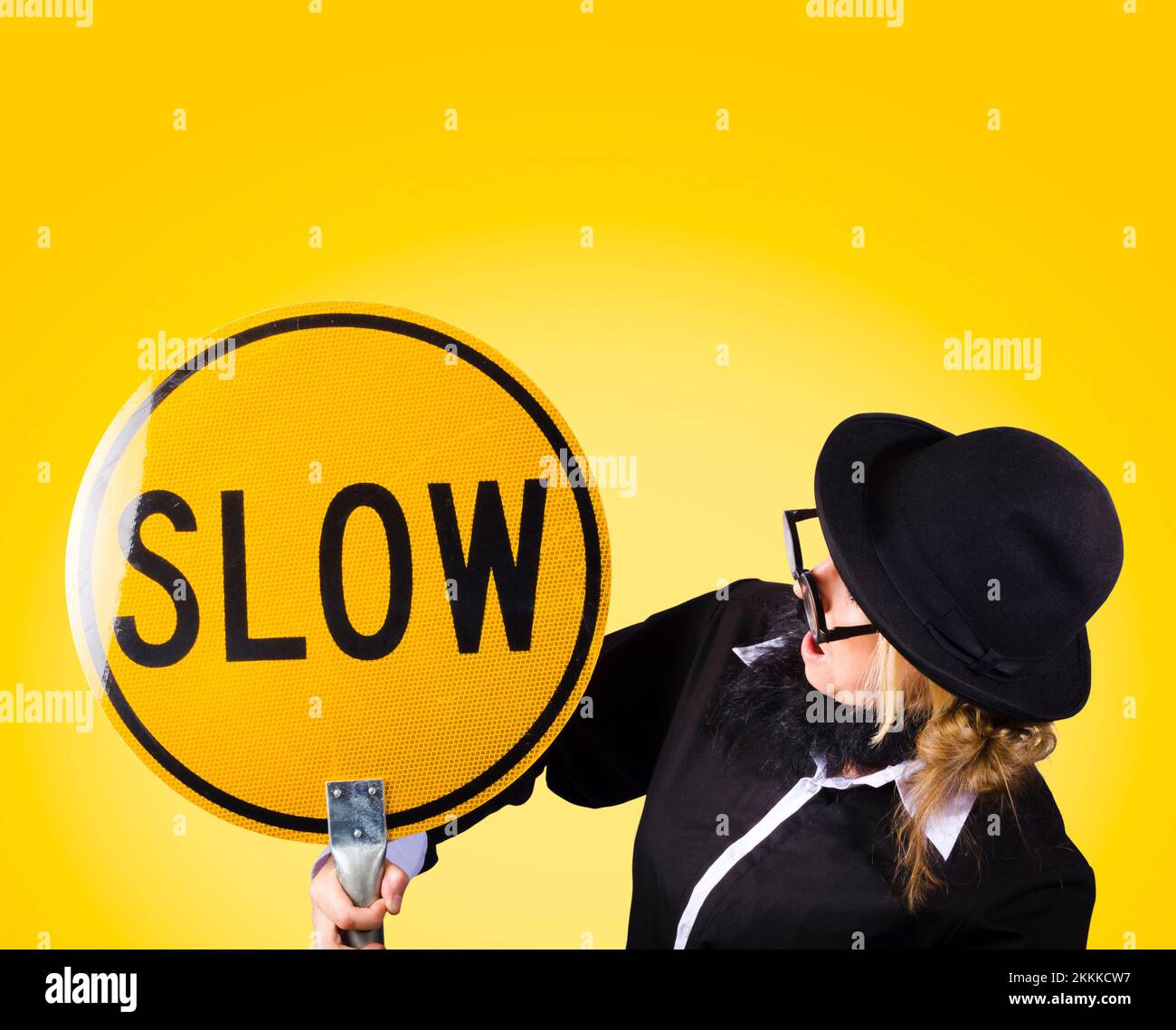 Odd businessman looking at slow traffic sign during difficult working ...