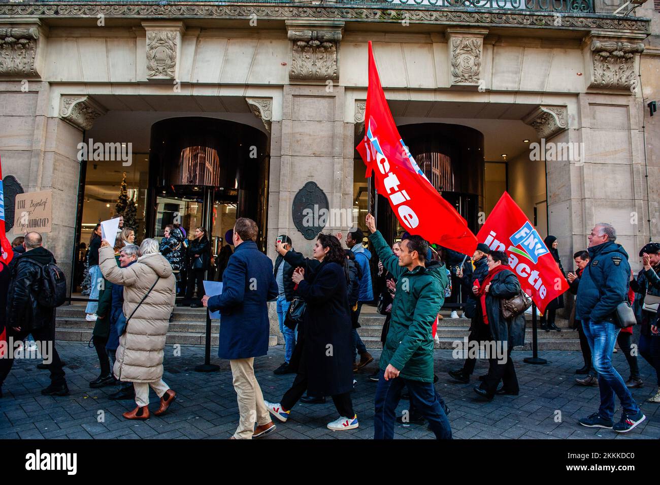 Protesters march with placards and flags in front of the department ...