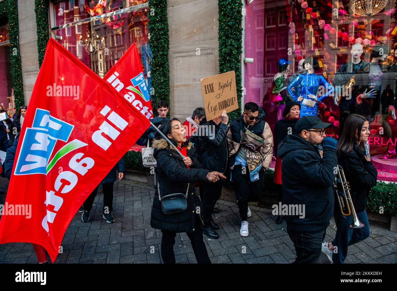 Protesters hold a big flags of the syndicate FNV in front of the ...
