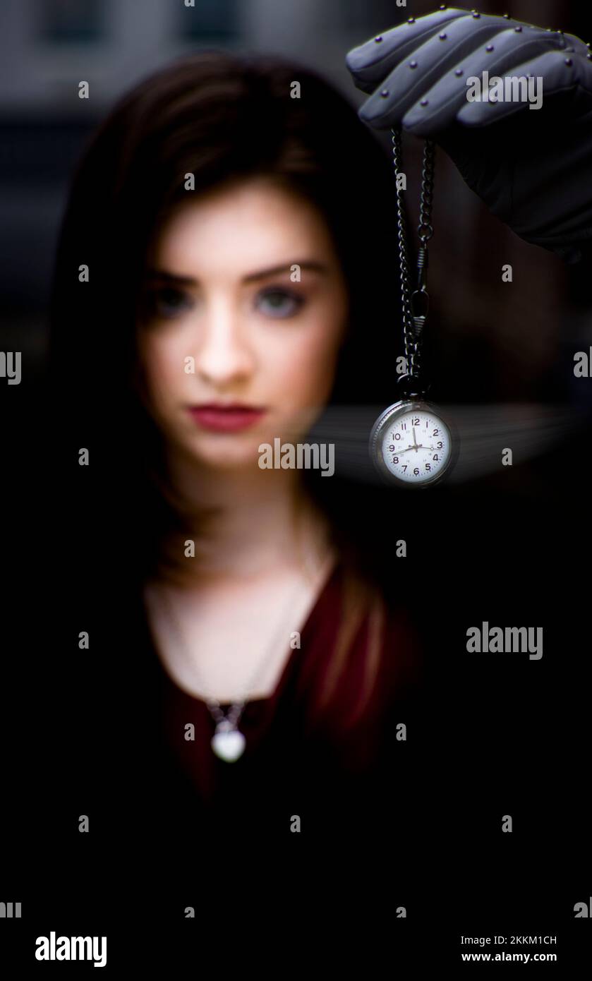 Portrait Of Hypnotised Young Woman With Gloved Hand And Stopwatch In ...