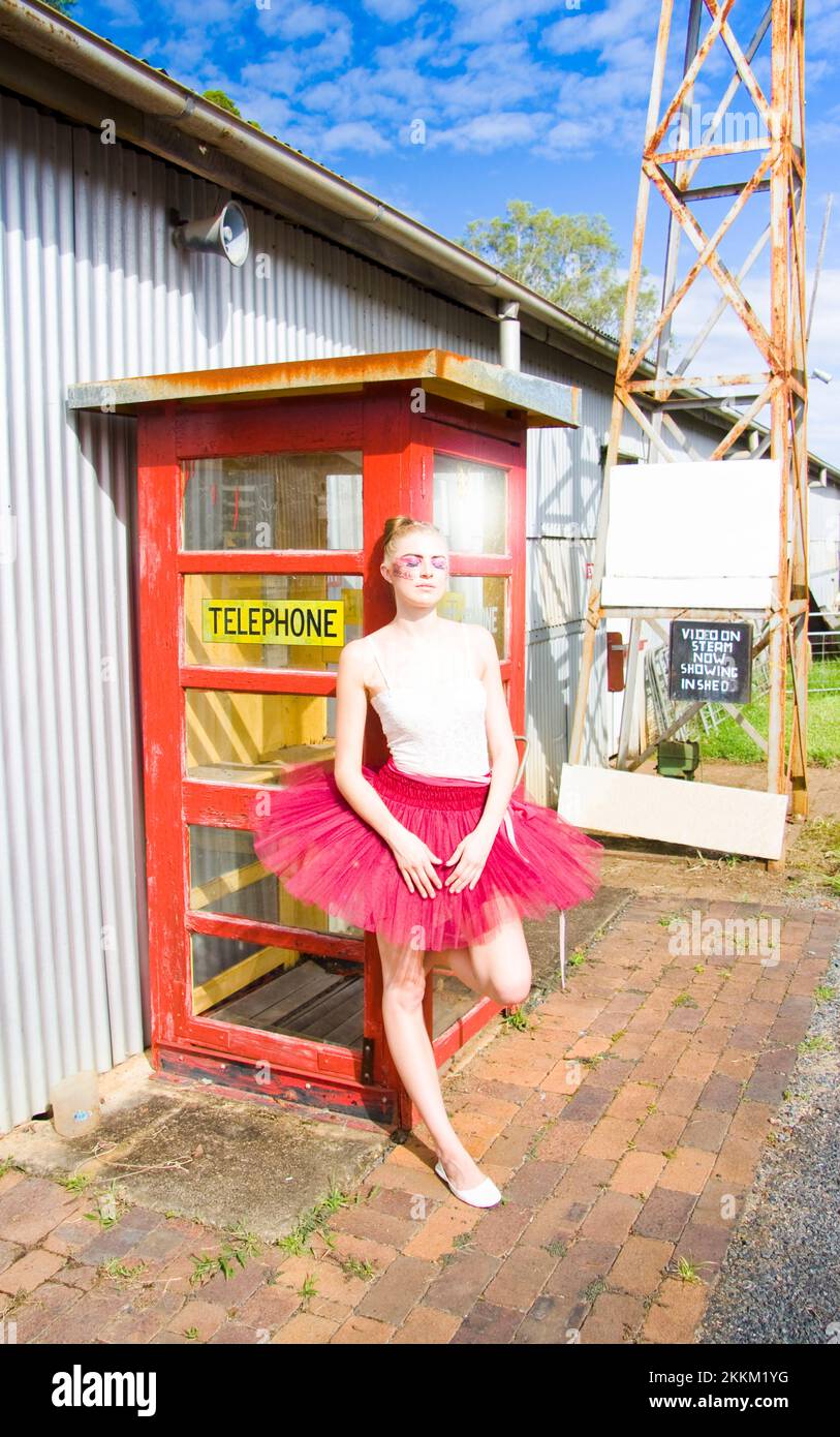 Dancing Ballerina Stands Next To A Vintage Red Telephone Box In A ...